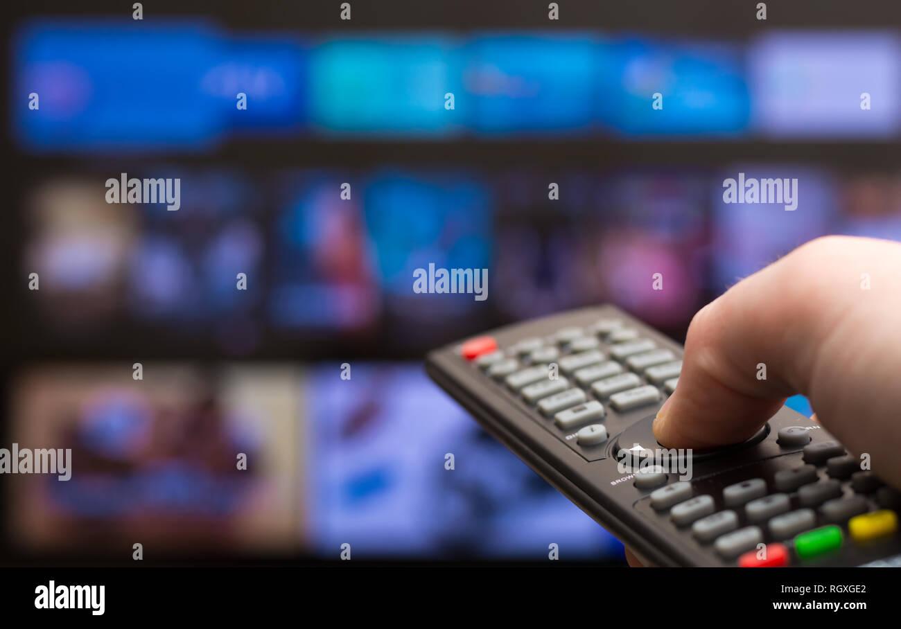 TV remote in hand Stock Photo - Alamy