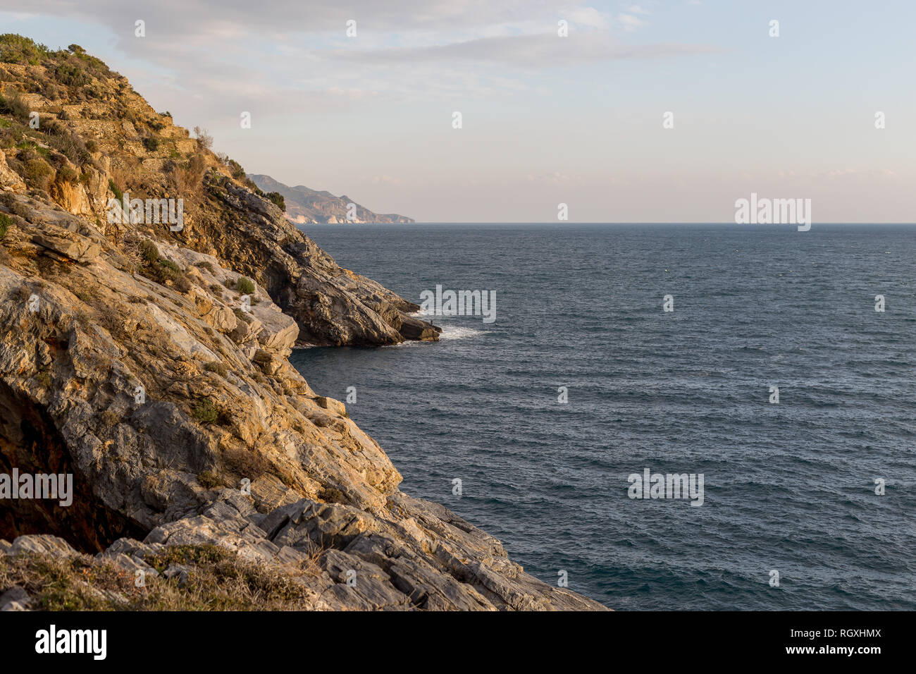 Horizontal seascape with steep rocky slopes by the sea. Negative space ...