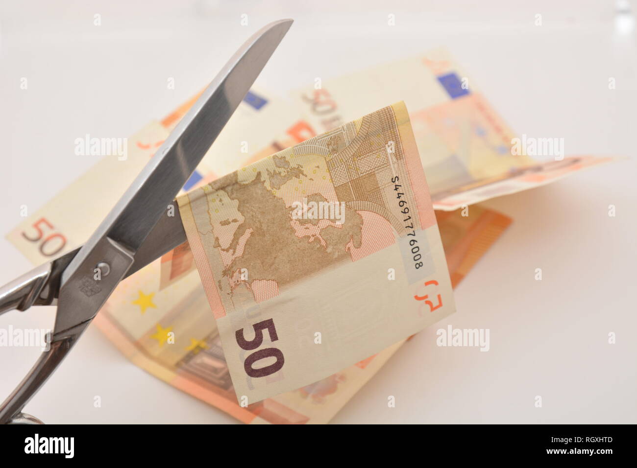 money euro and scissors on white background Stock Photo - Alamy