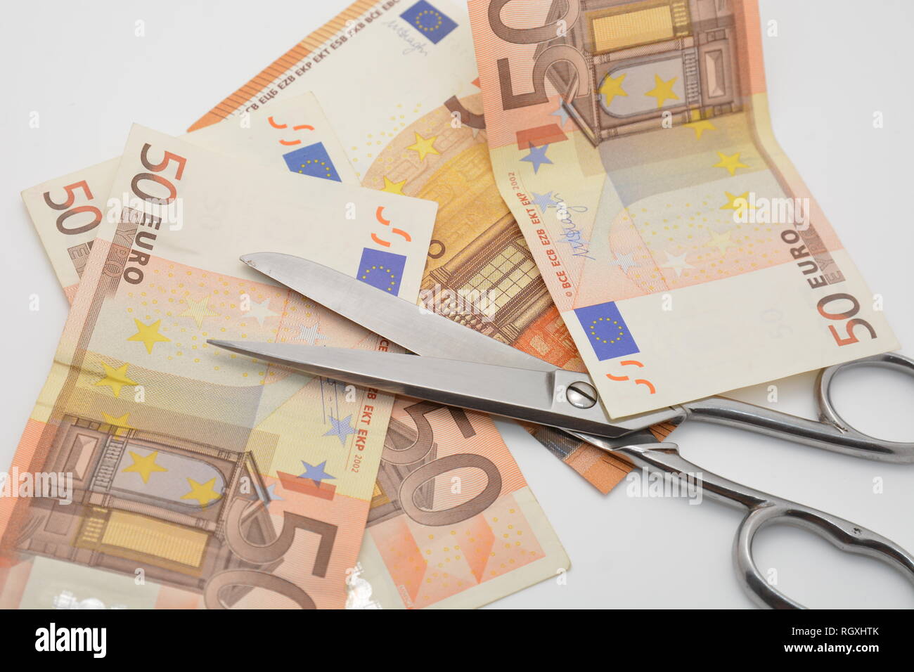 money euro and scissors on white background Stock Photo - Alamy