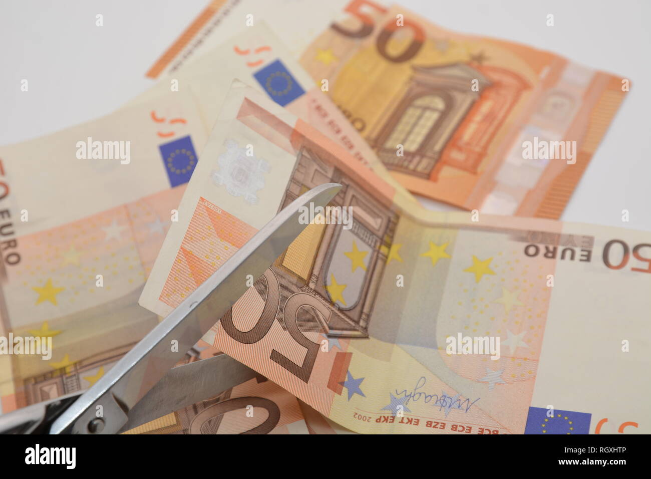 money euro and scissors on white background Stock Photo - Alamy
