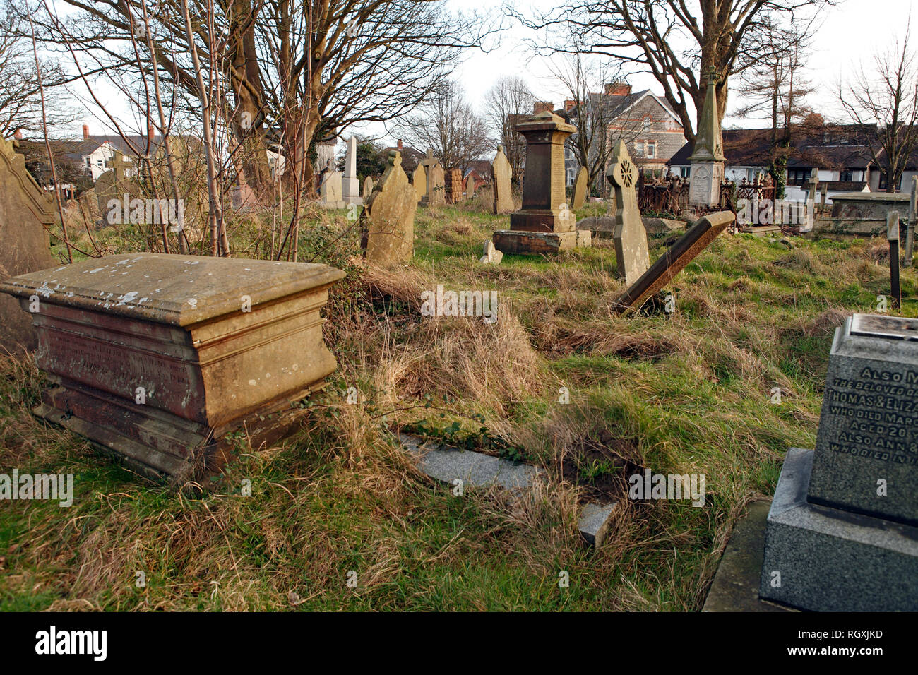 overgrown graveyard falling into disrepair. Sunken graves, brambles ...