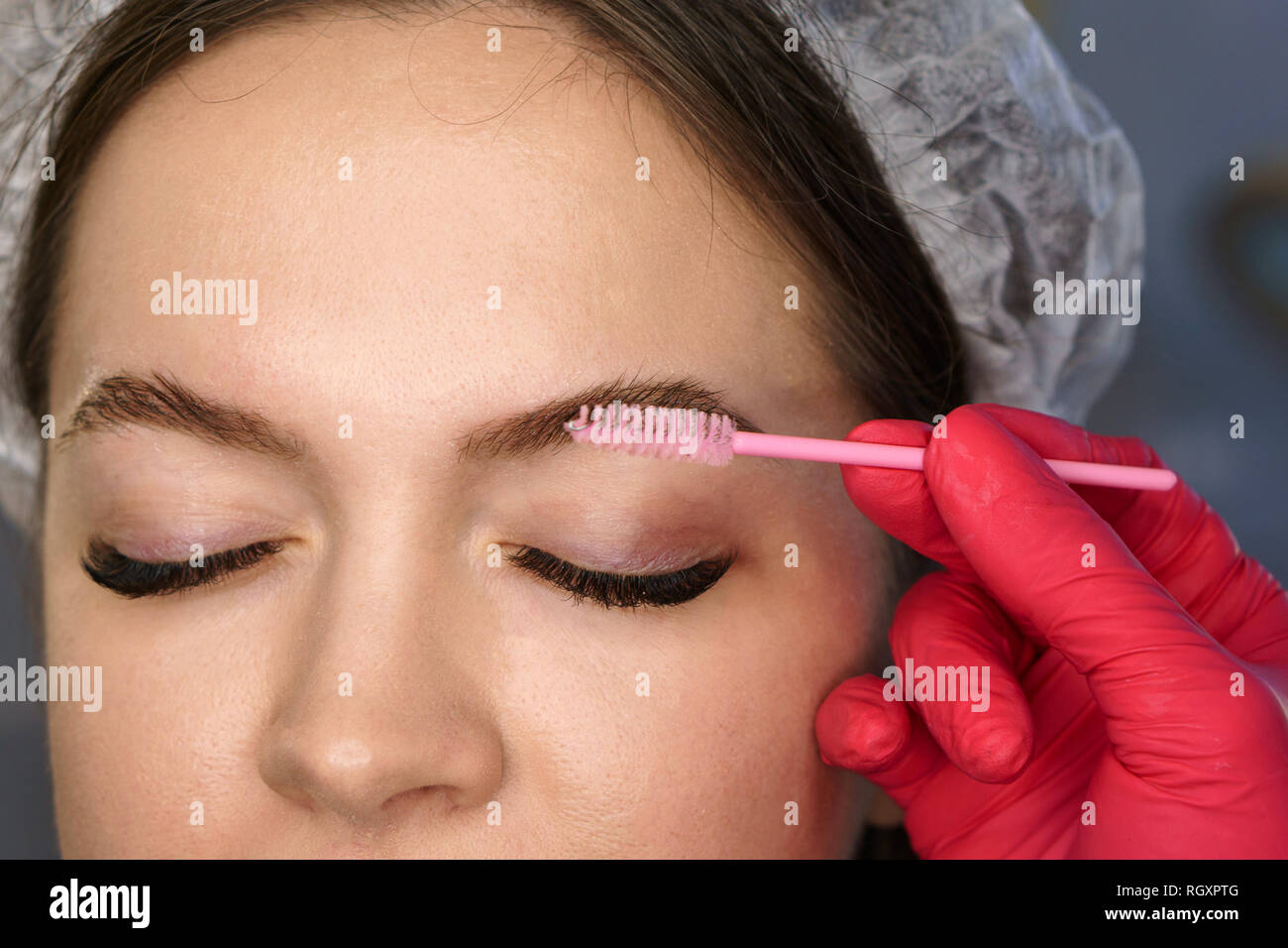 Eyebrow correction. Combing eyebrows and giving direction of hair ...