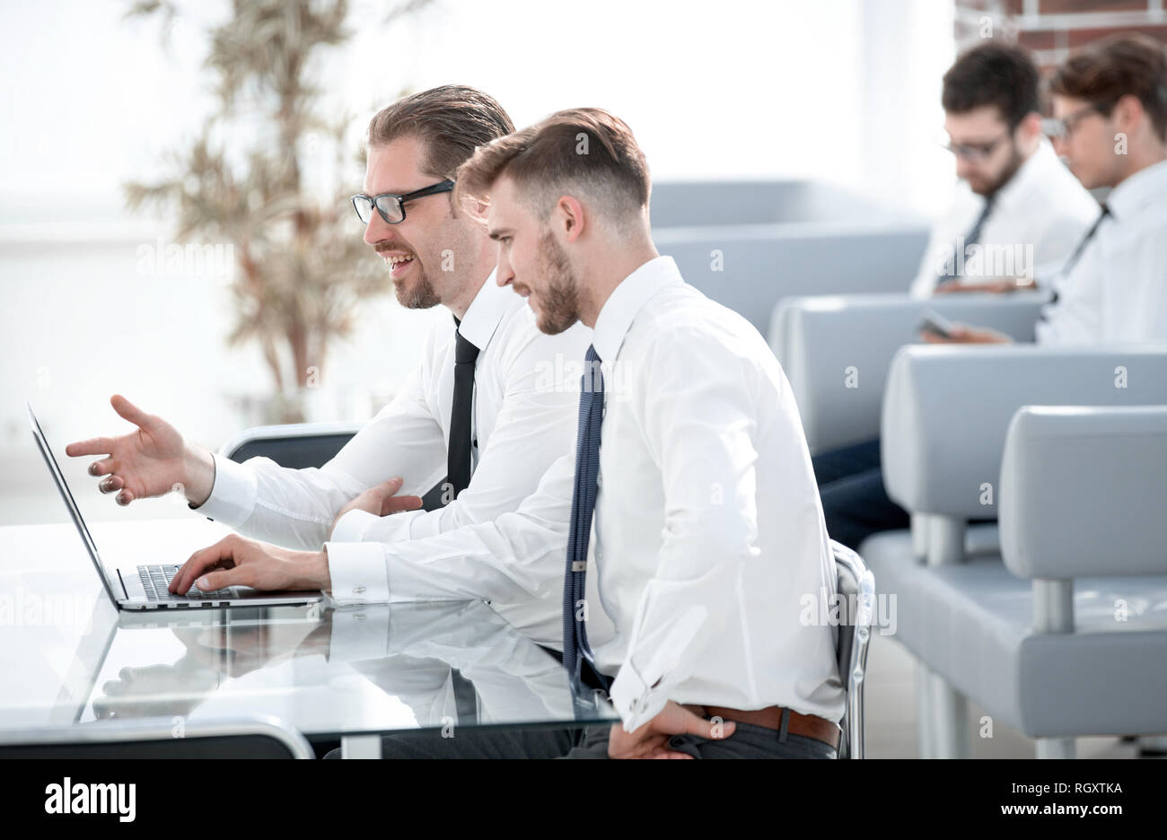 employees sitting at a Desk in a modern office Stock Photo - Alamy