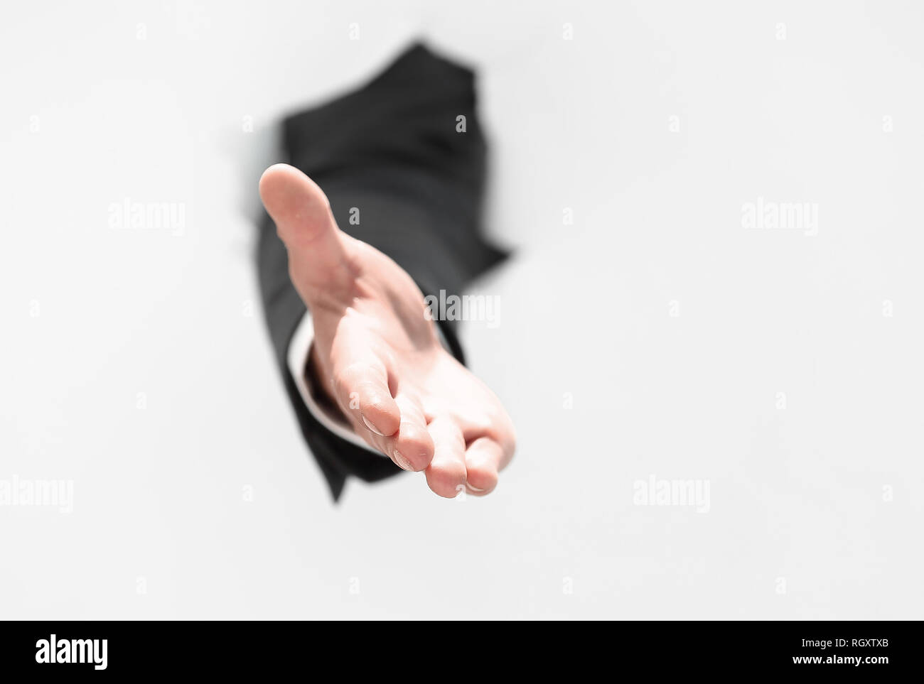 Hand breaking through paper holding hi-res stock photography and images ...