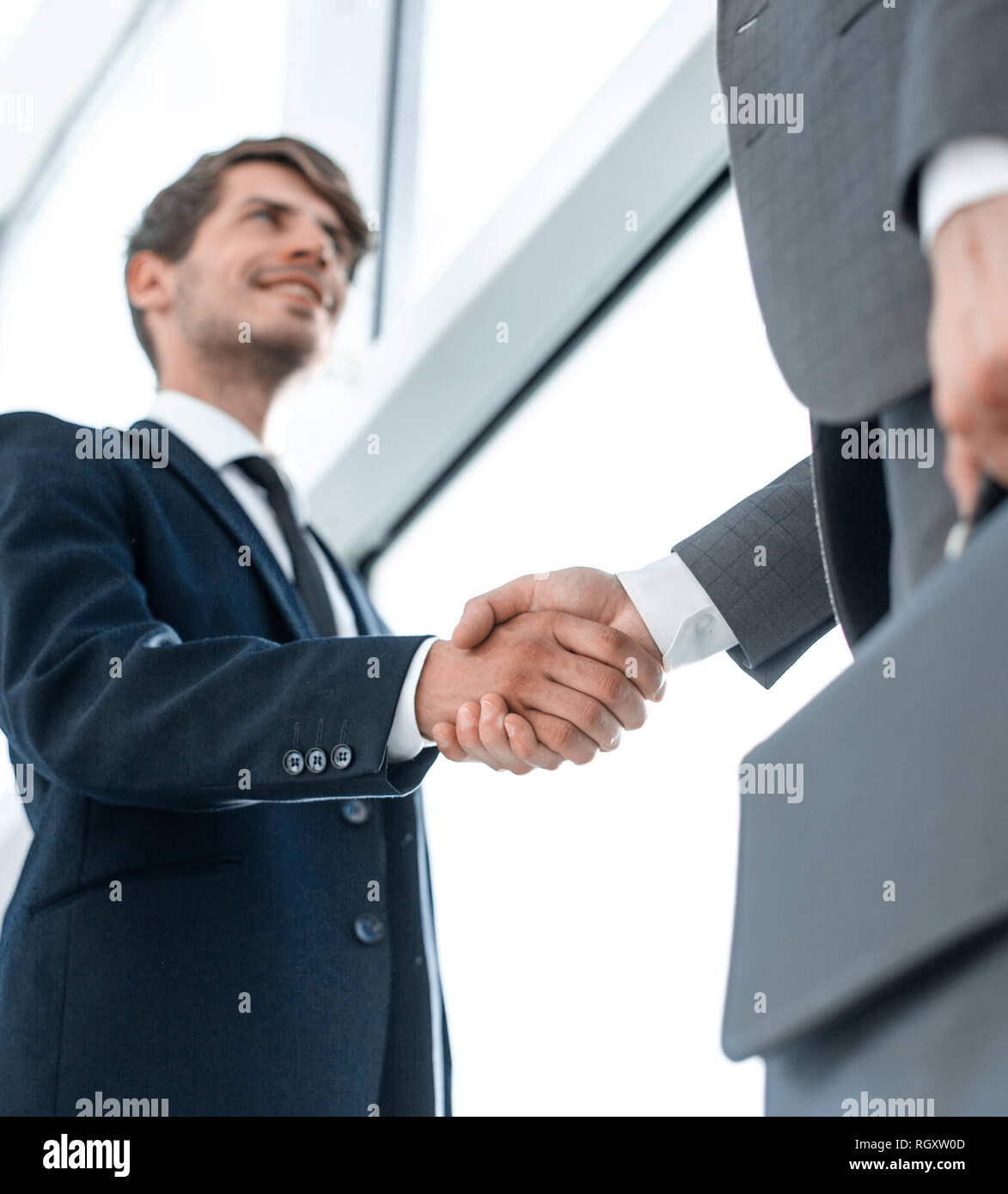 bottom view. handshake business partners in the office Stock Photo - Alamy