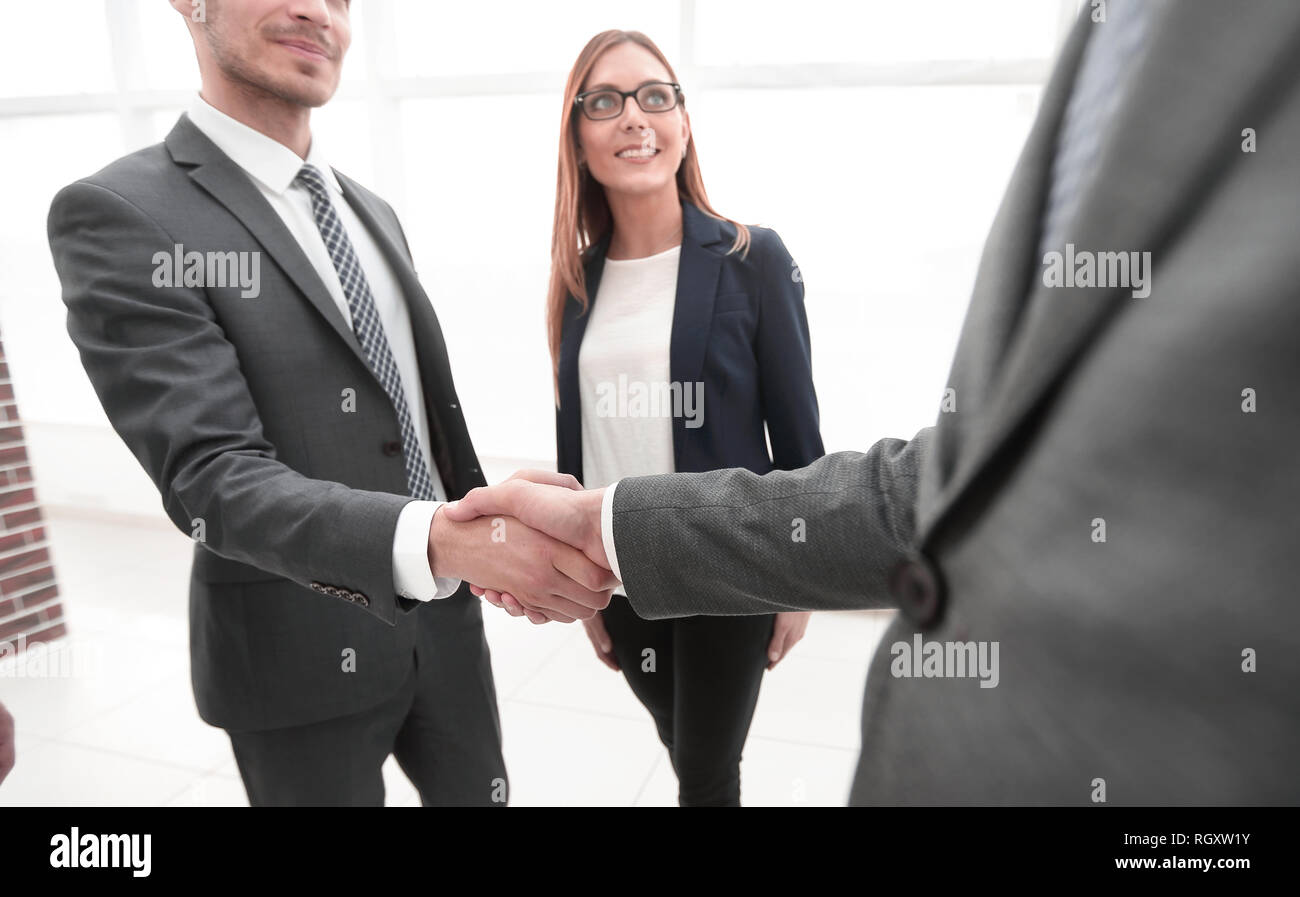 Business shaking hands in the office Stock Photo - Alamy