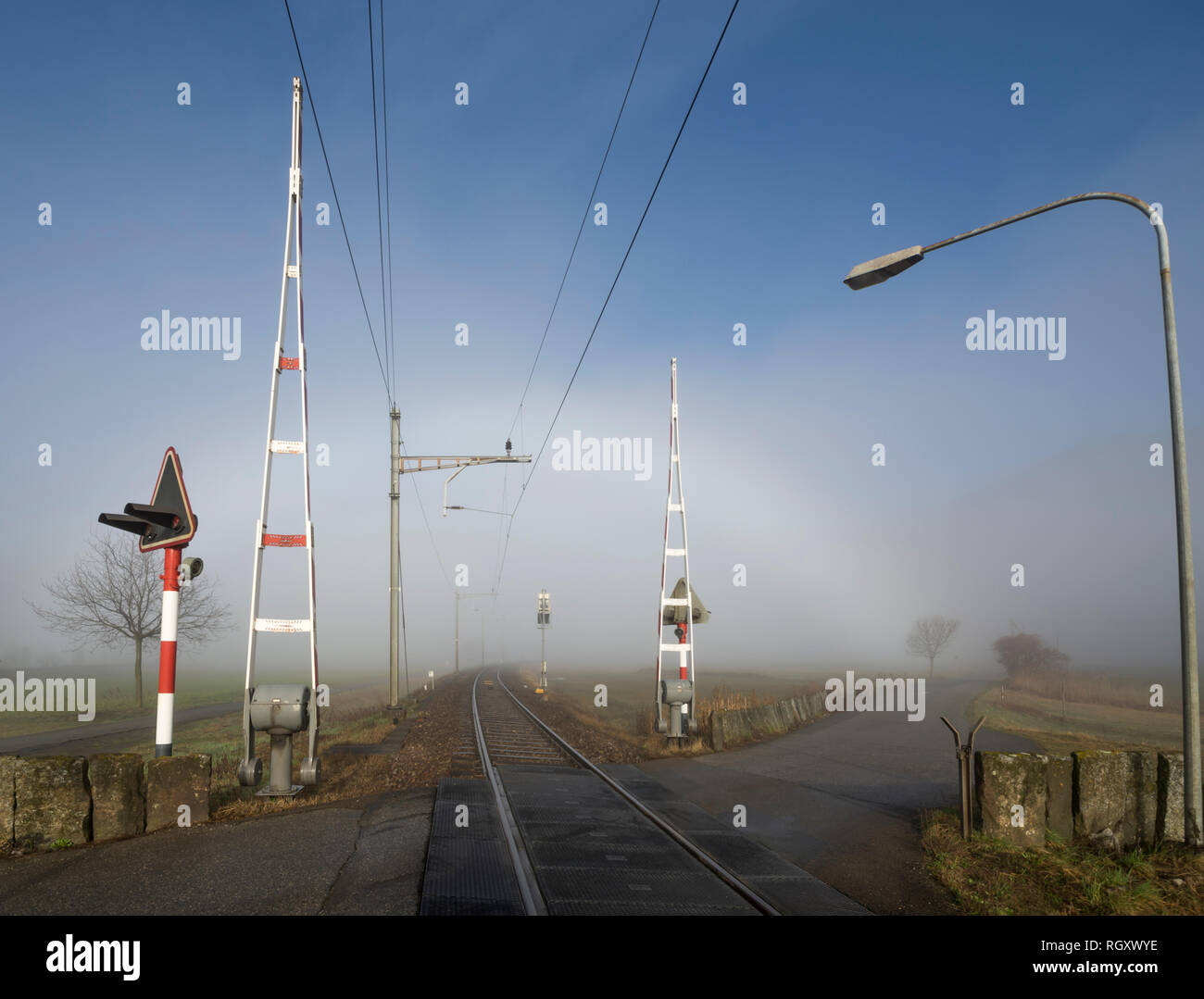 Railroad Crossing in the Fog and Blue Sky in Ticino, Switzerland Stock ...