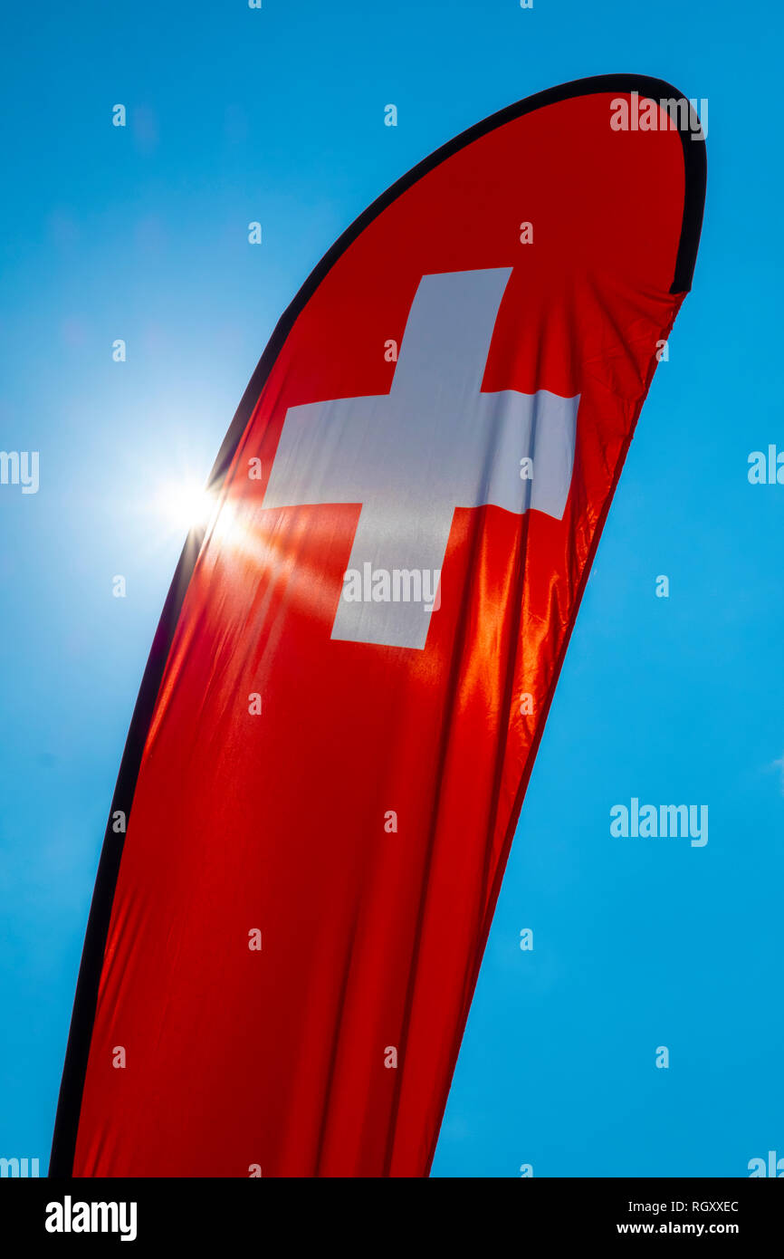 Swiss Banner Flag with Sunlight and Against Blue Sky in Switzerland ...