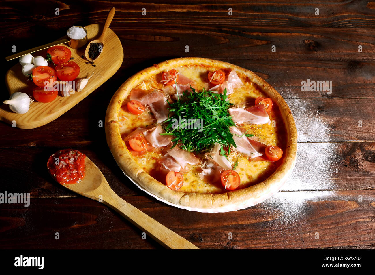 pizza on wood table with ingredients Stock Photo - Alamy
