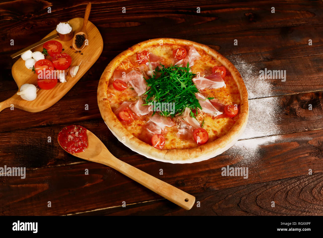 pizza on wood table with ingredients Stock Photo - Alamy