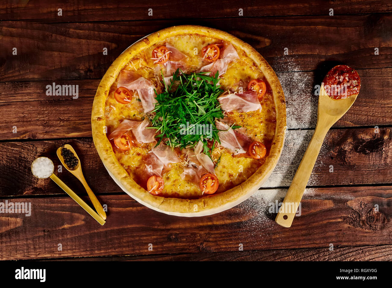 pizza on wood table with ingredients Stock Photo - Alamy