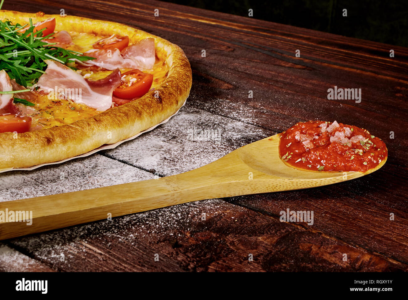 pizza on wood table with ingredients Stock Photo - Alamy