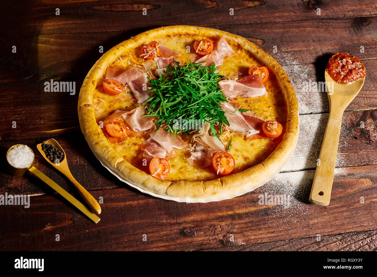 pizza on wood table with ingredients Stock Photo - Alamy