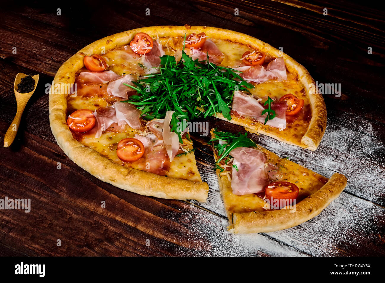 pizza on wood table with ingredients Stock Photo - Alamy