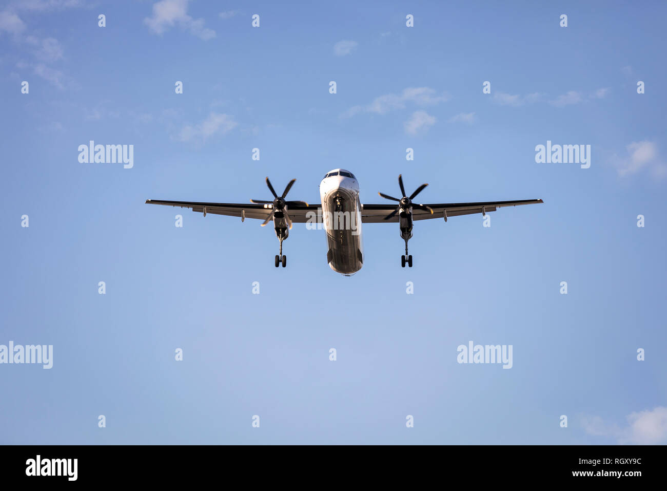 Flying passenger Airplane preparing to land Stock Photo - Alamy