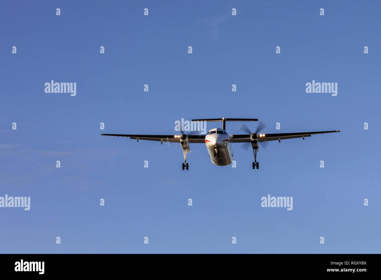 Flying aircraft preparing to land Stock Photo - Alamy