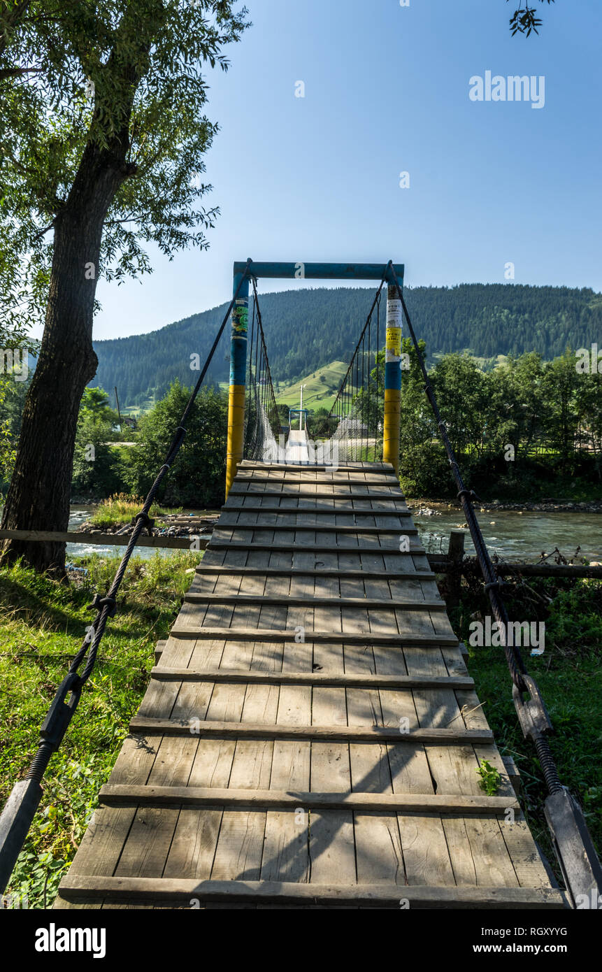 Small rope bridge over the river. Vertical shot Stock Photo - Alamy