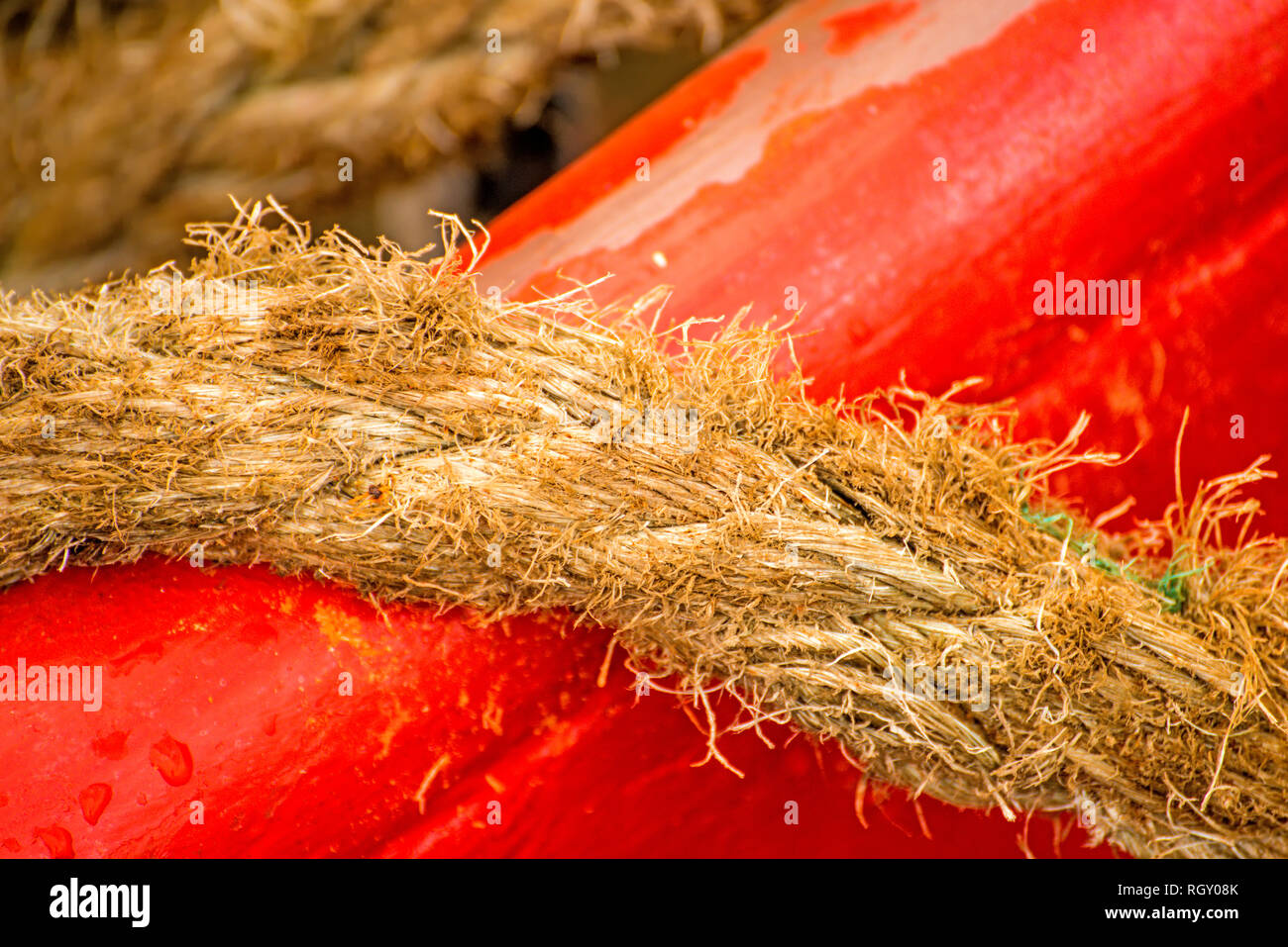 Mooring line of a trawler on a red ship hull Stock Photo - Alamy