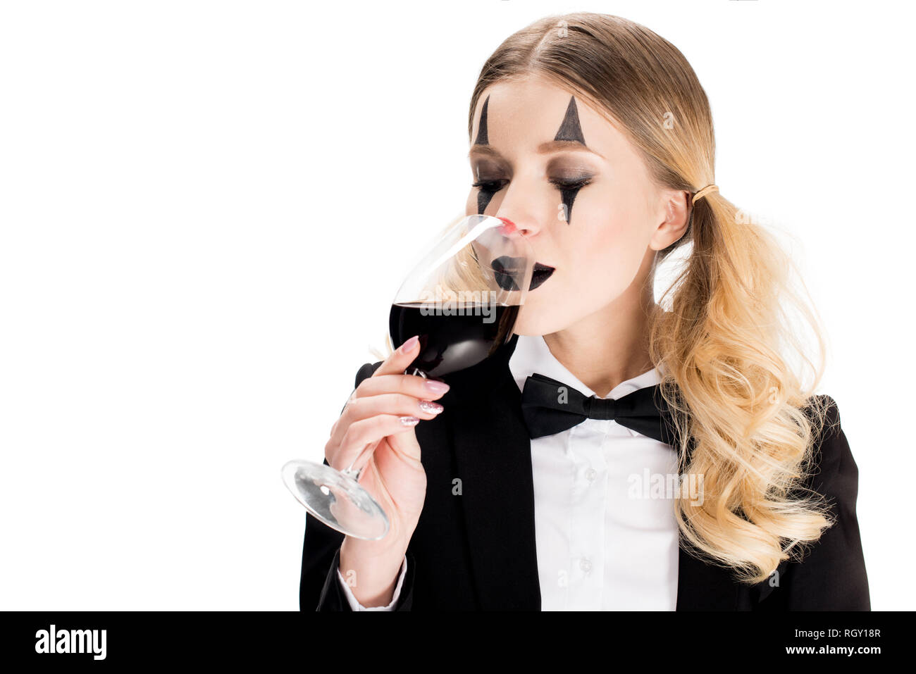 female blonde clown in suit drinking wine isolated on white Stock Photo ...