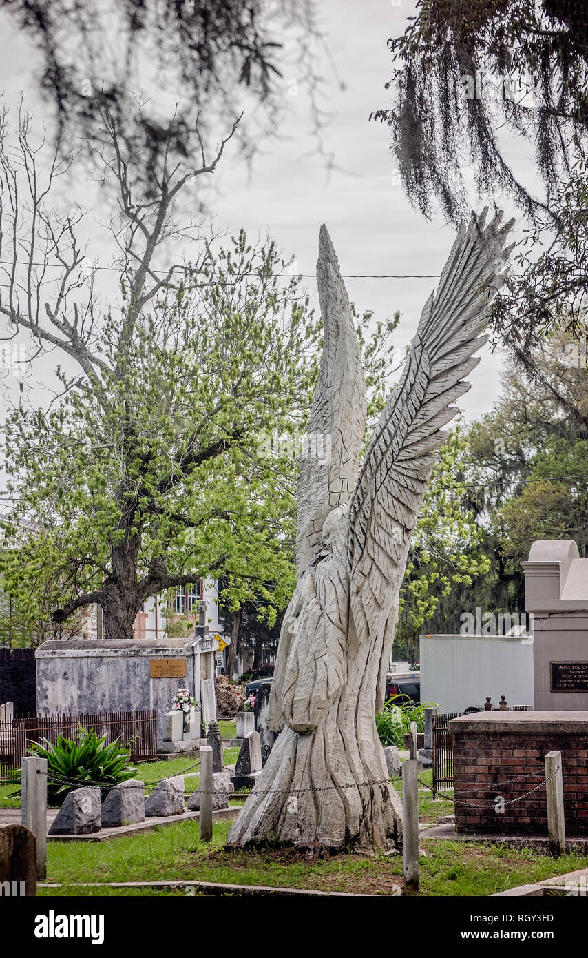 A wooden angel, carved from a tree damaged by Hurricane Katrina, is ...