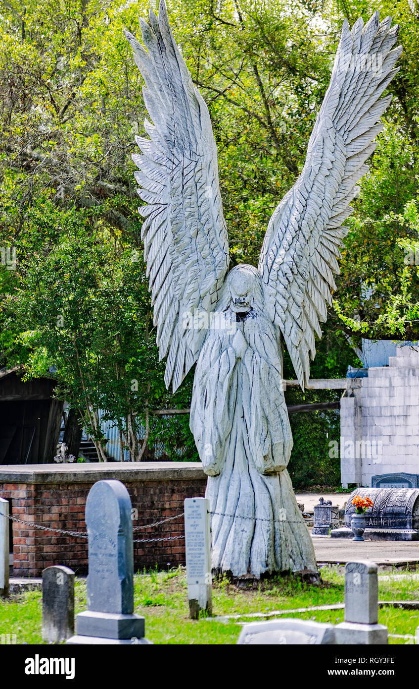 A wooden angel, carved from a tree damaged by Hurricane Katrina, is ...