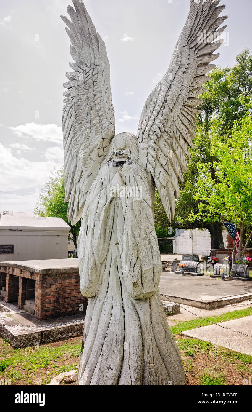 A wooden angel, carved from a tree damaged by Hurricane Katrina, is ...