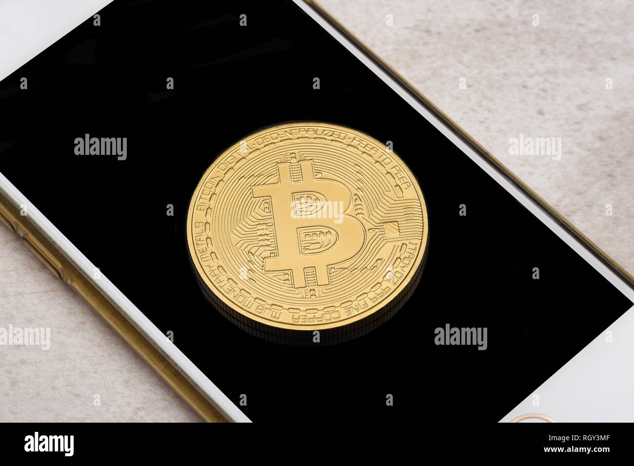 E-Conmmerce Concept: A Bit Coin on top of a smart phone screen Stock ...