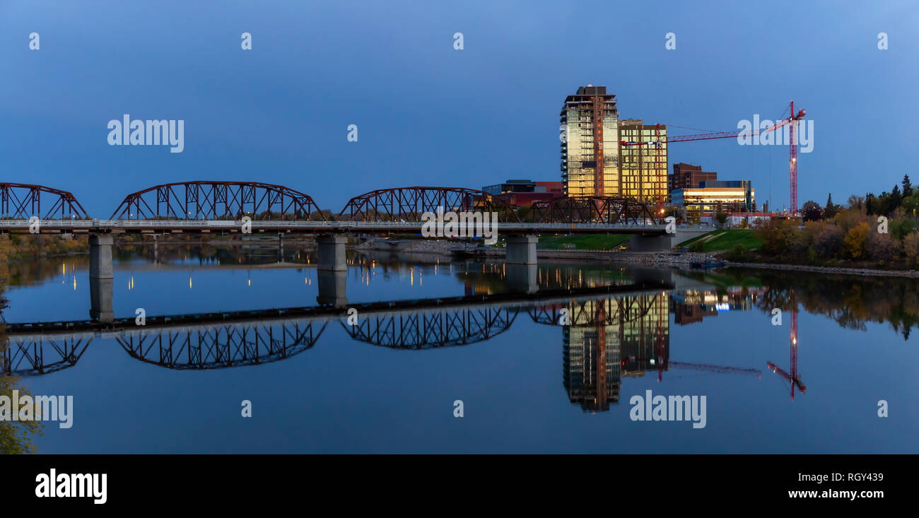 Bridge over the river in a downtown city during a vibrant sunrise ...