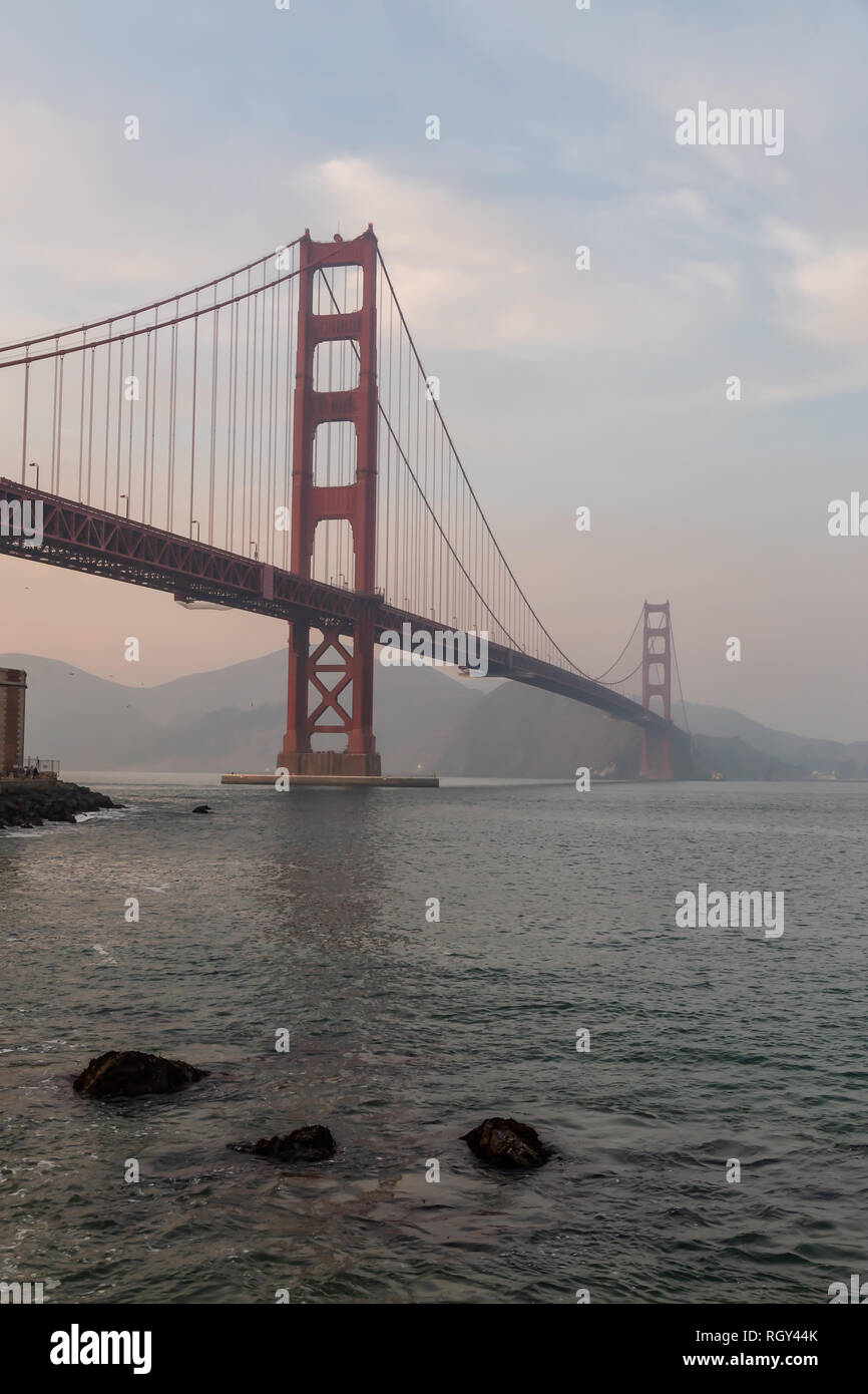 Beautiful view of Golden Gate Bridge during a cloudy sunset. Taken in ...
