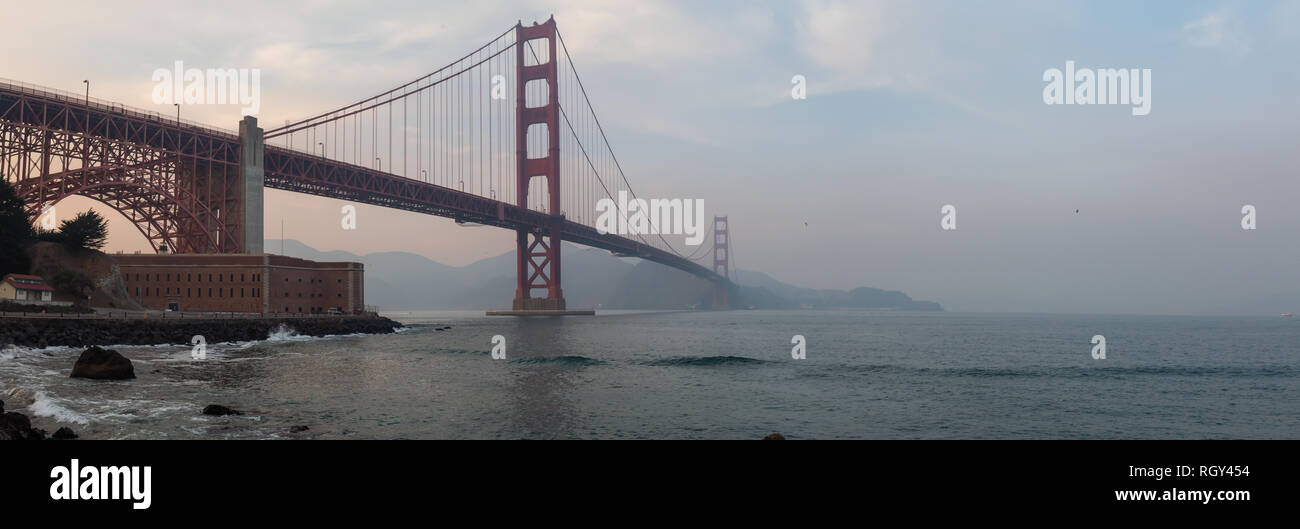 Beautiful panoramic view of Golden Gate Bridge during a cloudy sunset ...