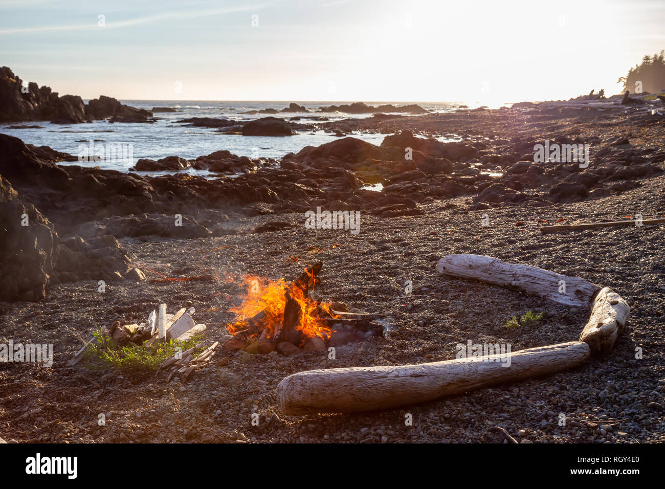 Camp fire on the beach during a vibrant summer sunset. Taken in ...
