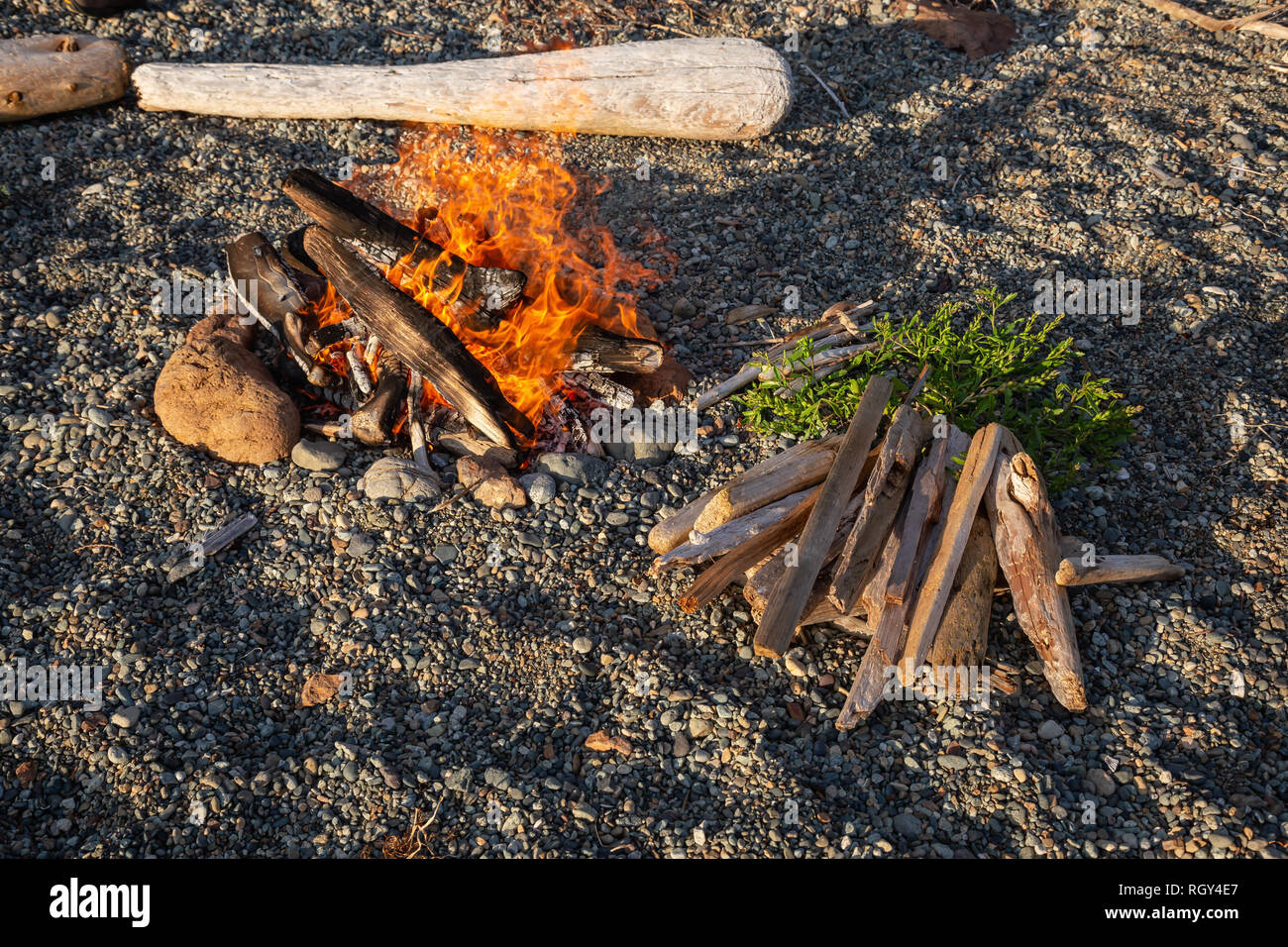 Camp fire on the beach during a vibrant summer sunset. Taken in ...