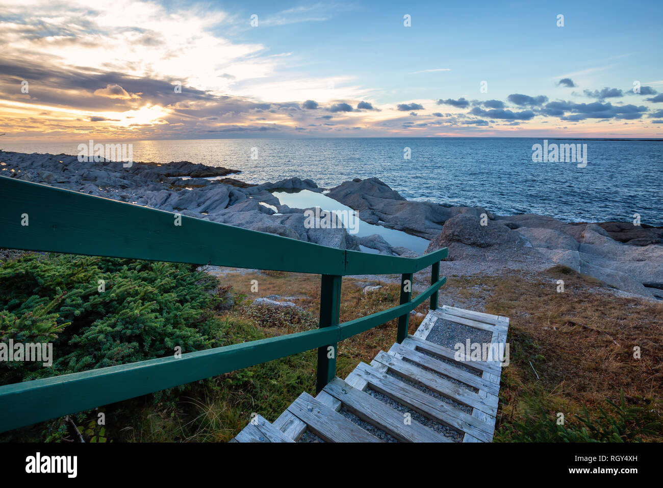 Wooden stairs going down to a beautiful rocky Atlantic Ocean Coast ...