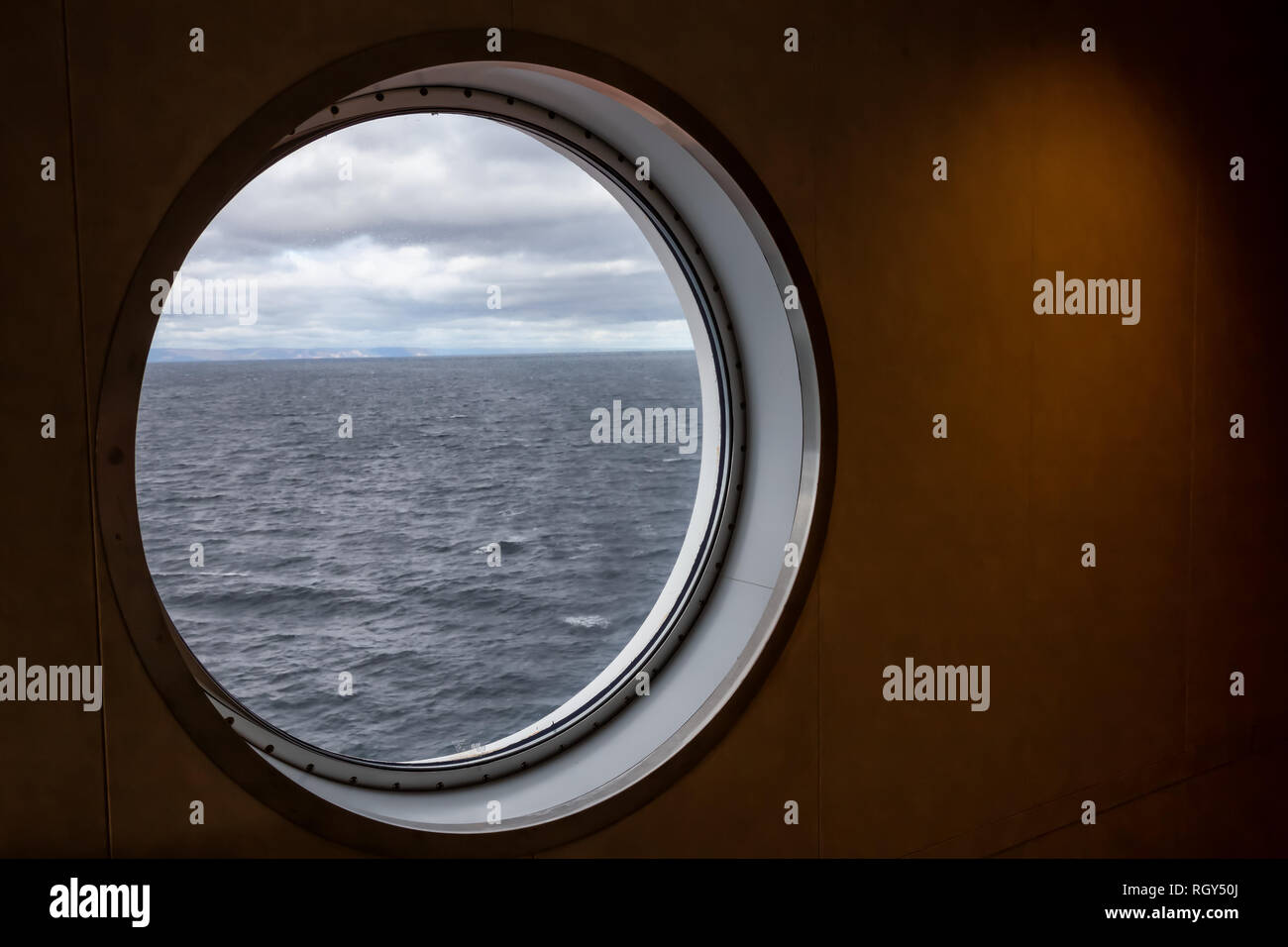 Round window on a ship looking outside onto the Atlantic Ocean Stock ...