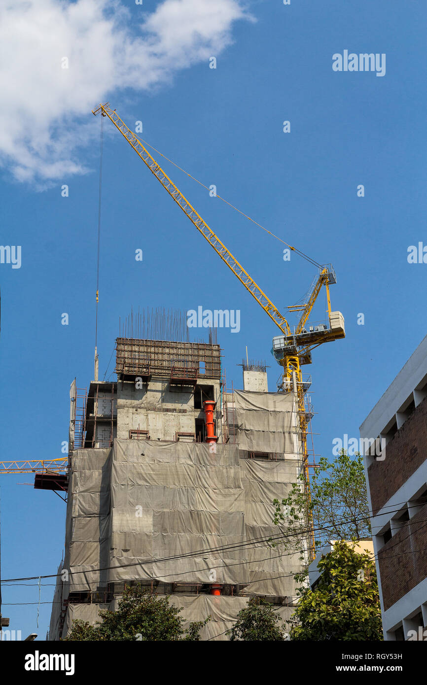 Lifting crane and building in construction site Stock Photo - Alamy