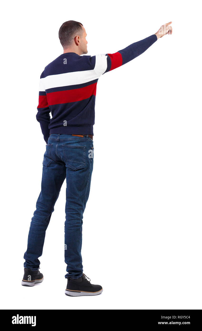 Back view of a stylish man in a sweater points his hand upwards. Rear ...