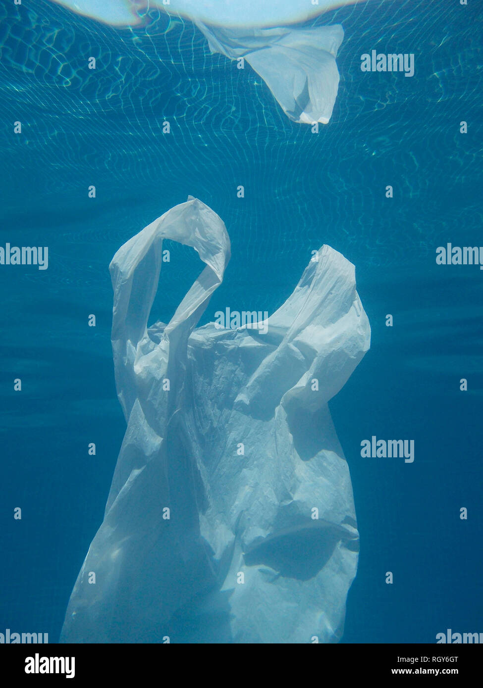 Plastic bag floating into the water. Polluted enviromental. Recycle ...