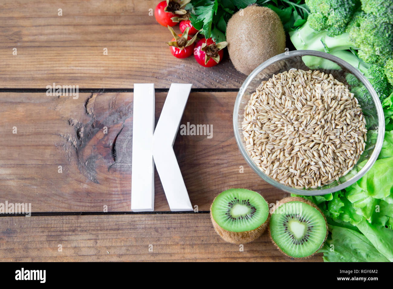 Foods highest in Vitamin K and letter K on a wooden board. Healthy ...