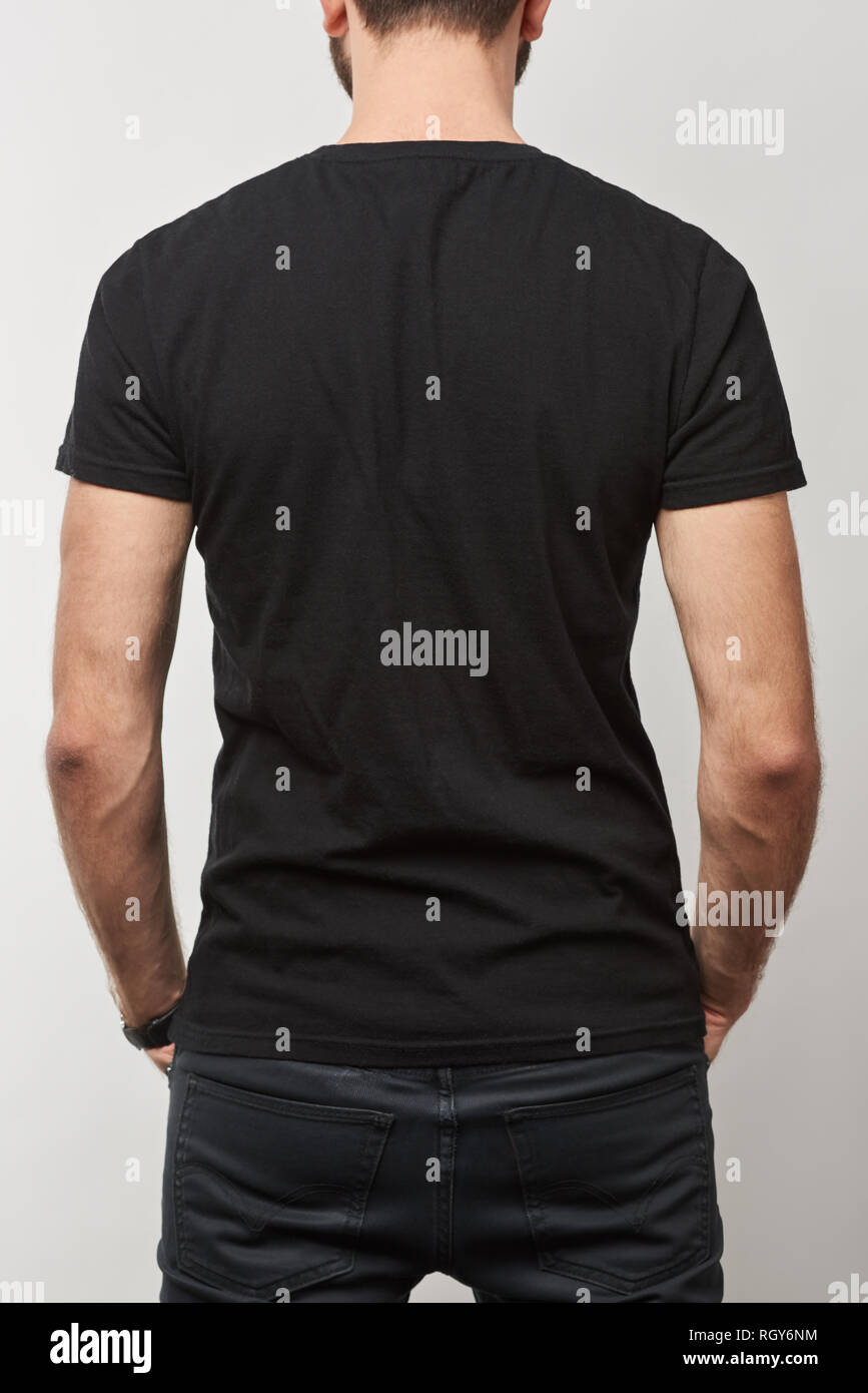 back view of man in black cotton t-shirt with copy space isolated on ...
