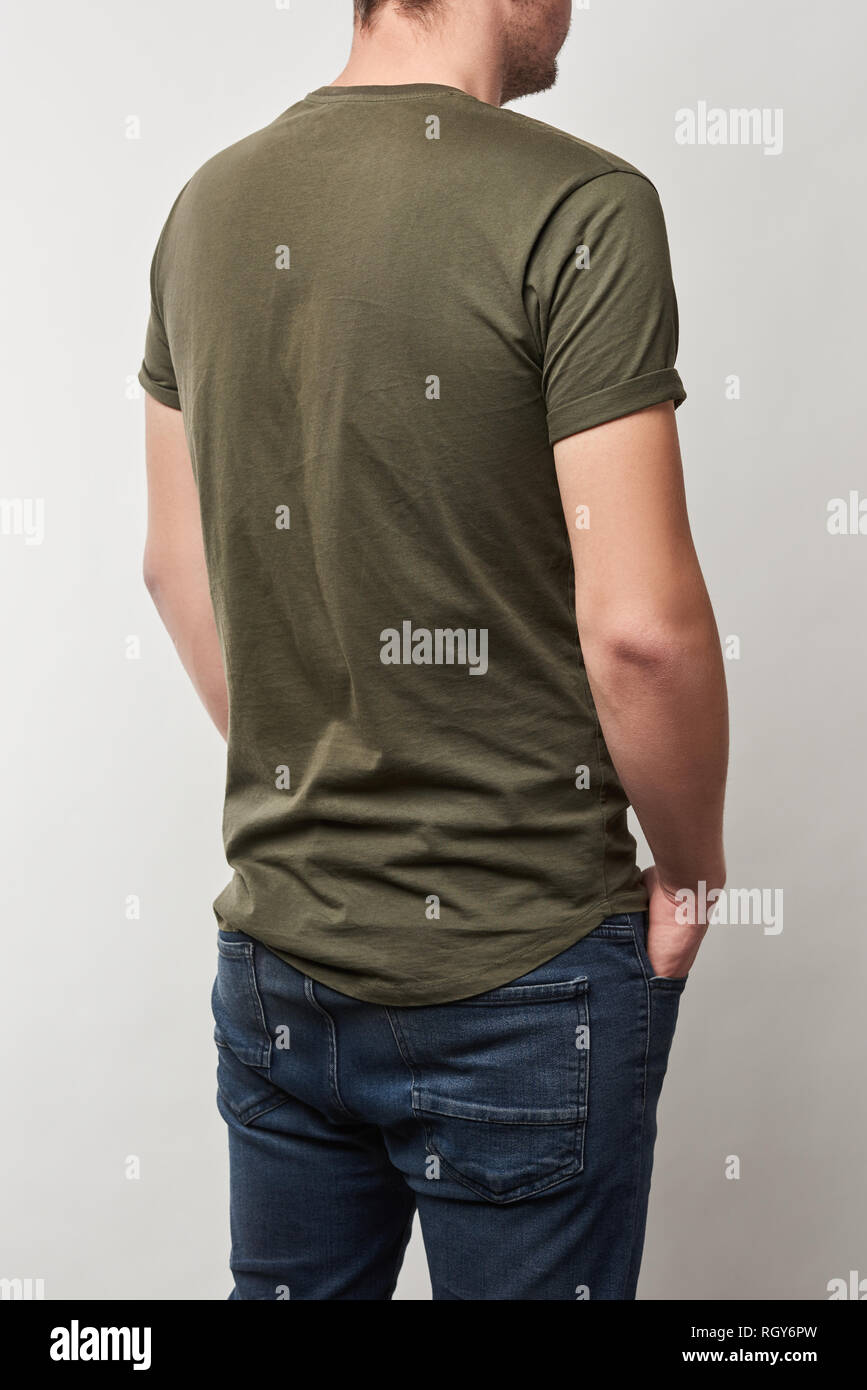 back view of man in khaki t-shirt with copy space isolated on grey ...