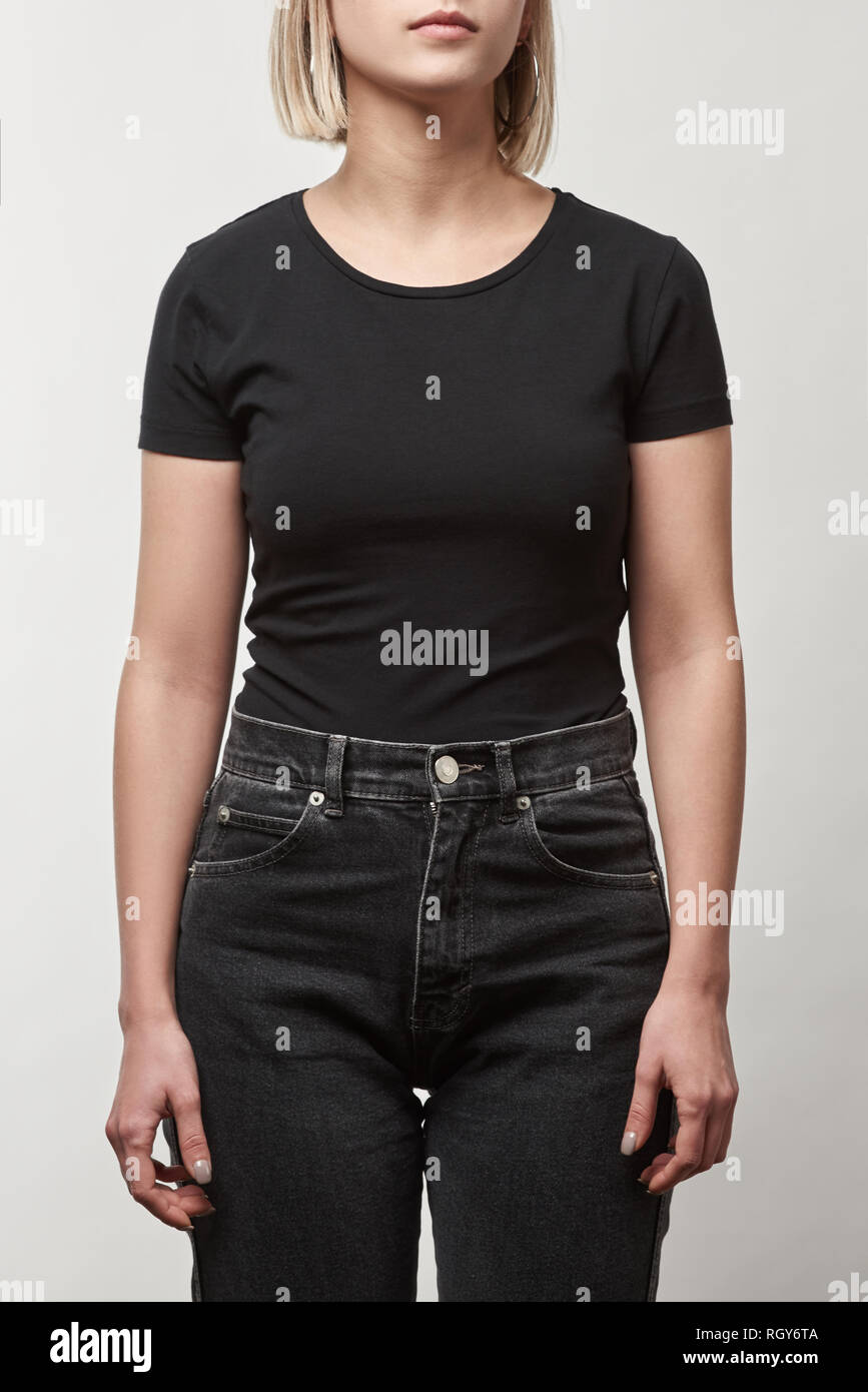 partial view of young woman in casual black t-shirt with copy space ...