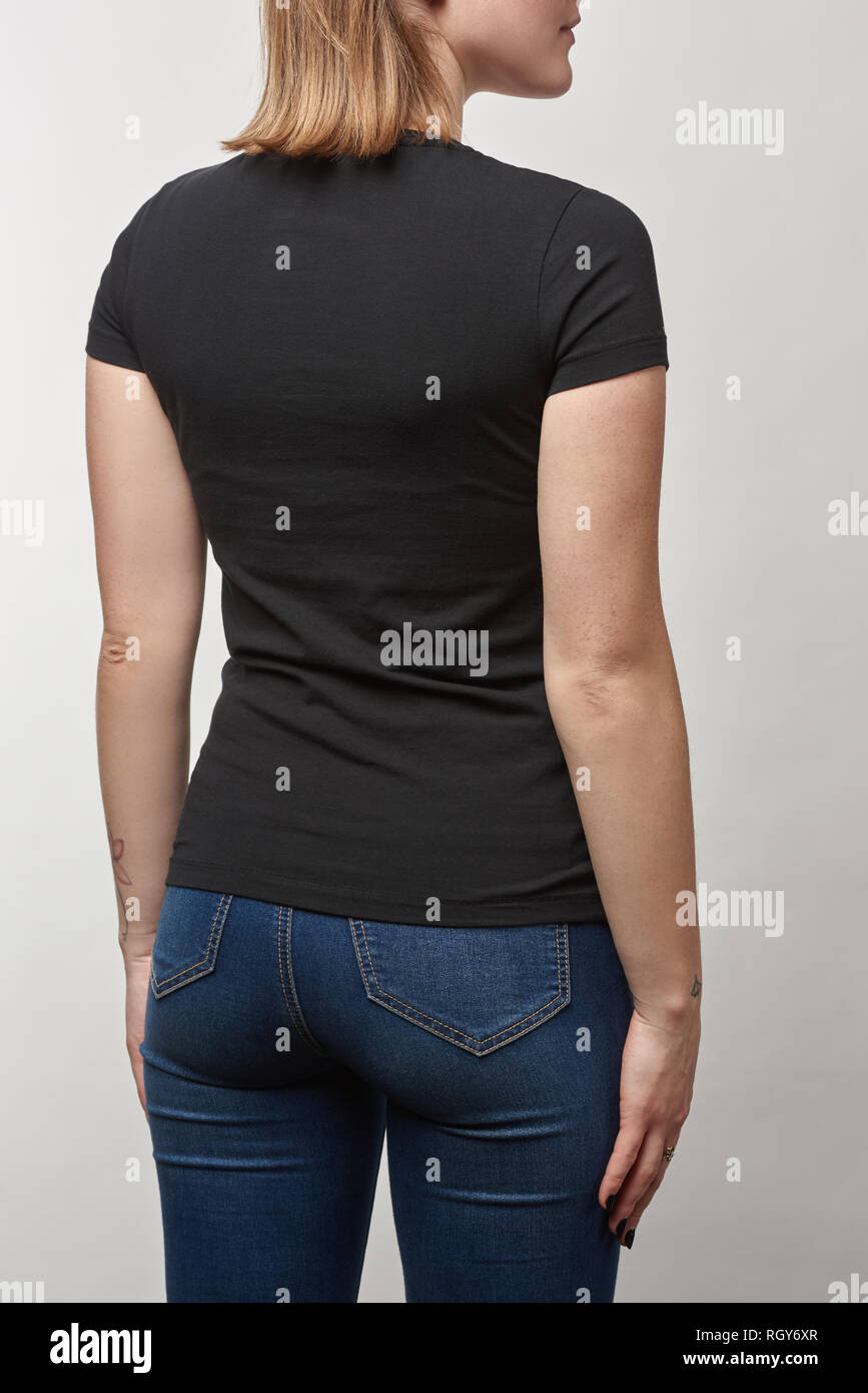 back view of young woman in black t-shirt with copy space isolated on ...