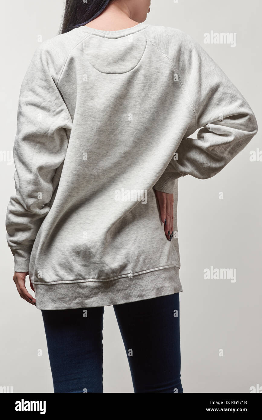 back view of young woman in grey hoodie with copy space isolated on ...