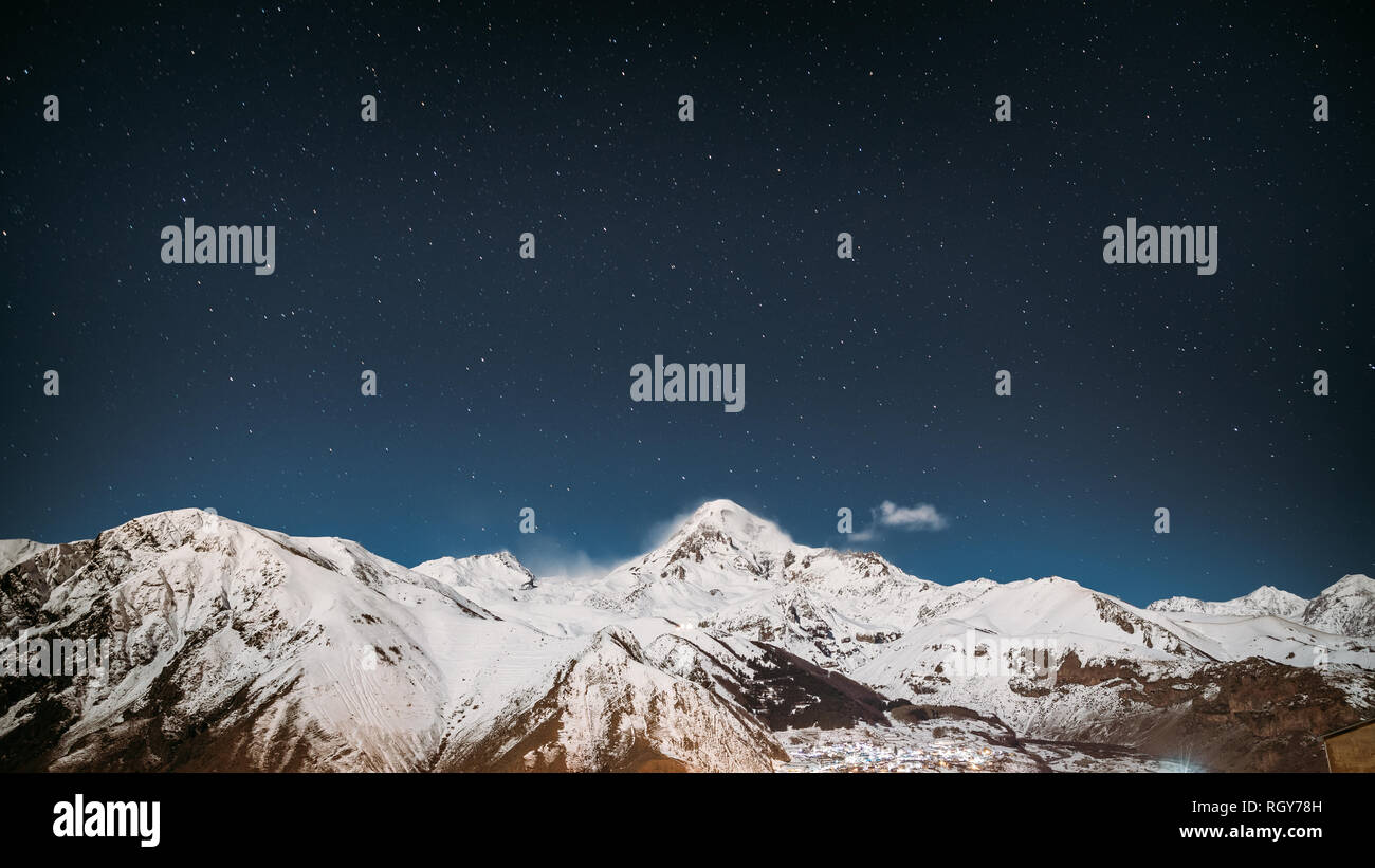 Stepantsminda, Georgia. Winter Night Starry Sky With Glowing Stars Over ...
