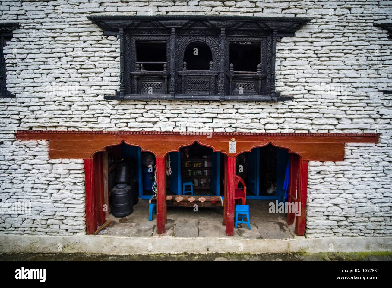 Facade and wooden carved windows of a traditional house, colorfully ...