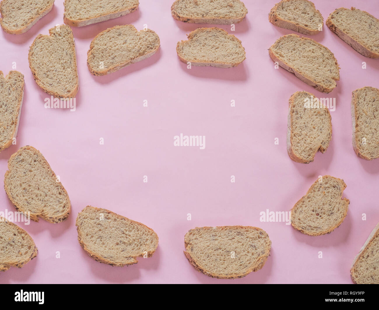 Bread with seeds pattern on pink background with copy space Stock Photo ...