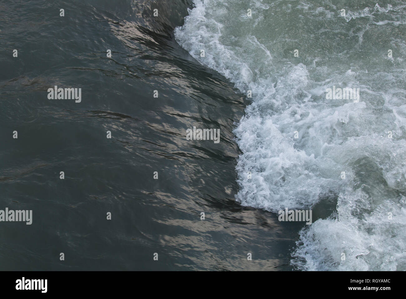 The stream of water flowing over rocks. Image close-up Stock Photo - Alamy
