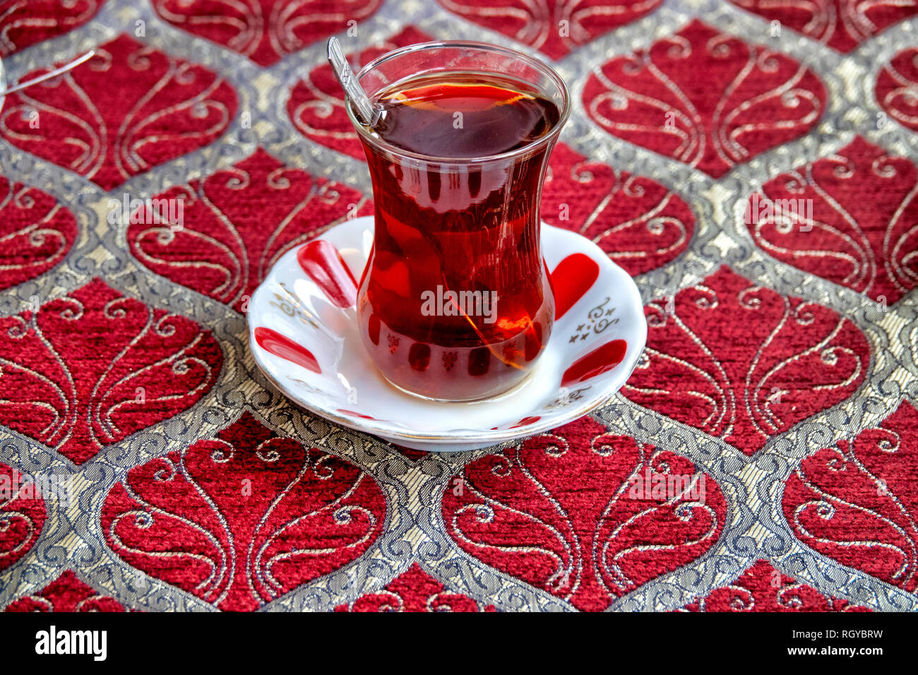 Turkish tea served in the typical manner, in a glass on a small saucer ...
