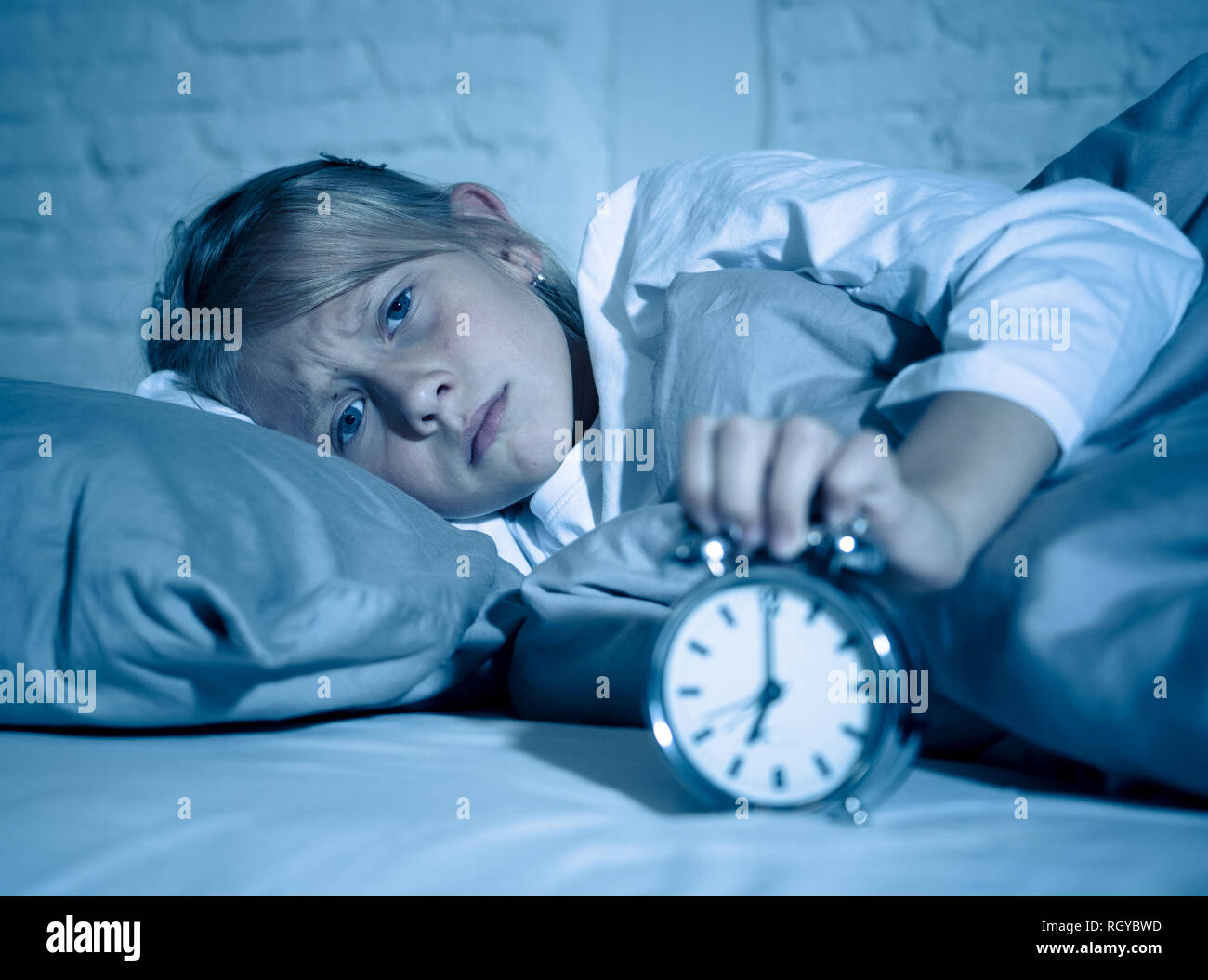 Sweet sleepless little girl stressed sad and angry in bed looking at ...